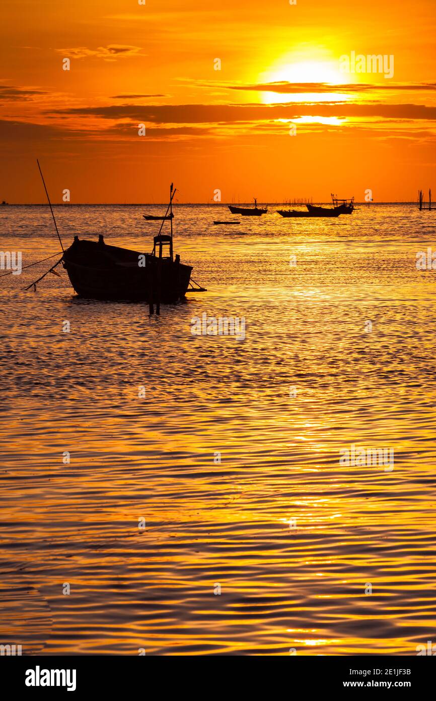boats are floating under colorful sky at sunset time Stock Photo - Alamy