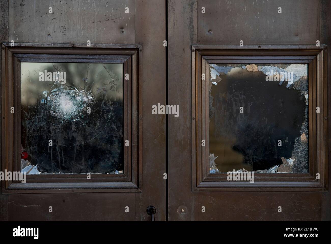 Broken windows of the front door of the U.S. Capitol is seen in the ...
