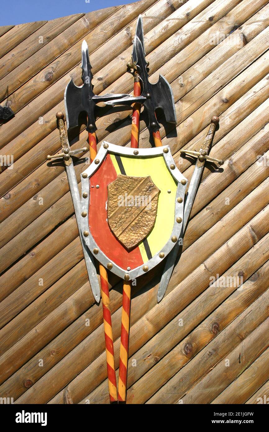 Replica of medieval weapons and shields on the entrance gates to a ...