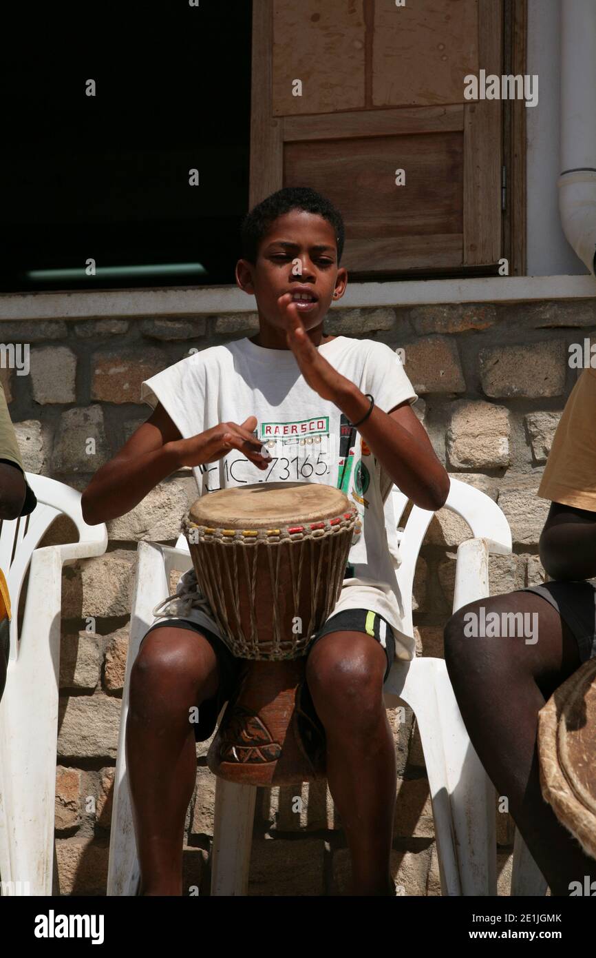 Local black drummer boys drum on the wall of a house in Palmeira on the ...