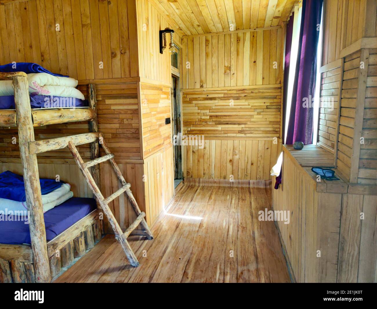 Photograph of Bunk beds inside a wooden cottage Stock Photo - Alamy