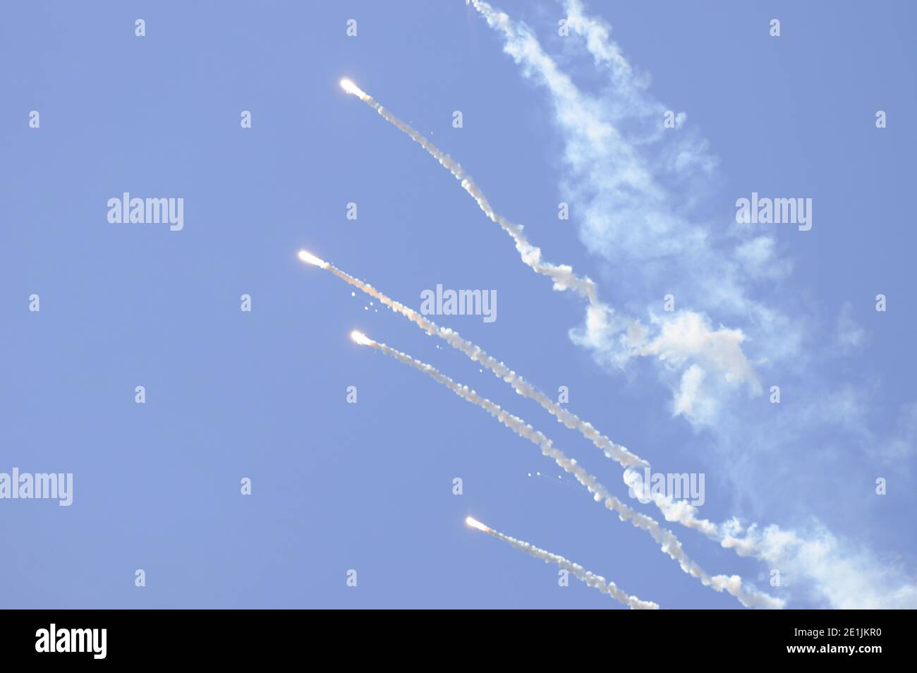 Flares in the sky fired by a jet fighter at an airshow Stock Photo - Alamy