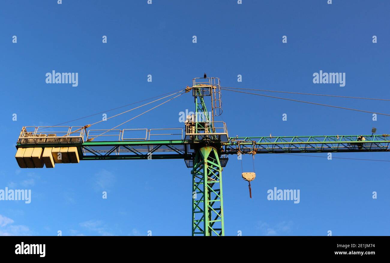Abandoned green remotely operated tall crane on an undeveloped building ...
