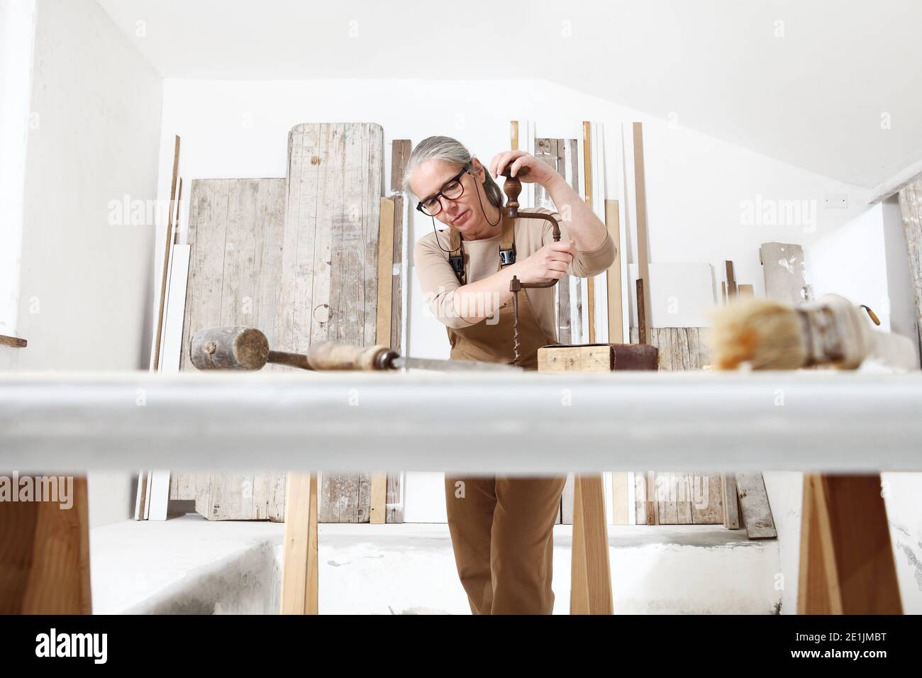 wood crafts, woman artisan carpenter works wood with old manual tools ...