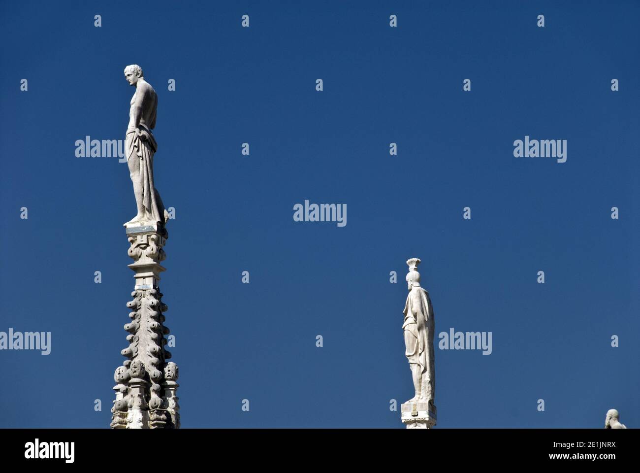 Statues atop spires on the Milan Cathedral (Duomo di Milano), the ...