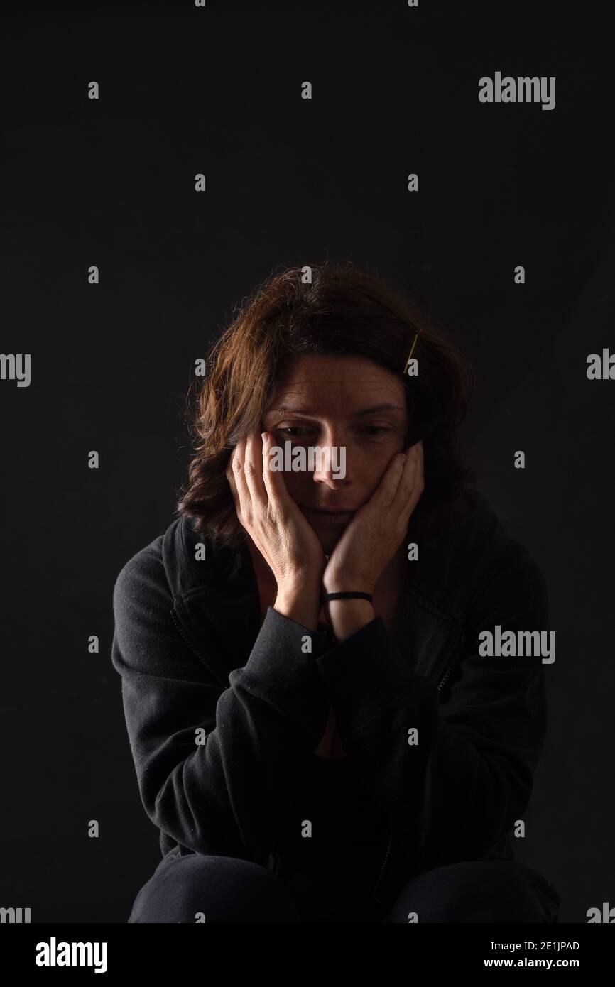 Woman with downcast eyes hi-res stock photography and images - Alamy