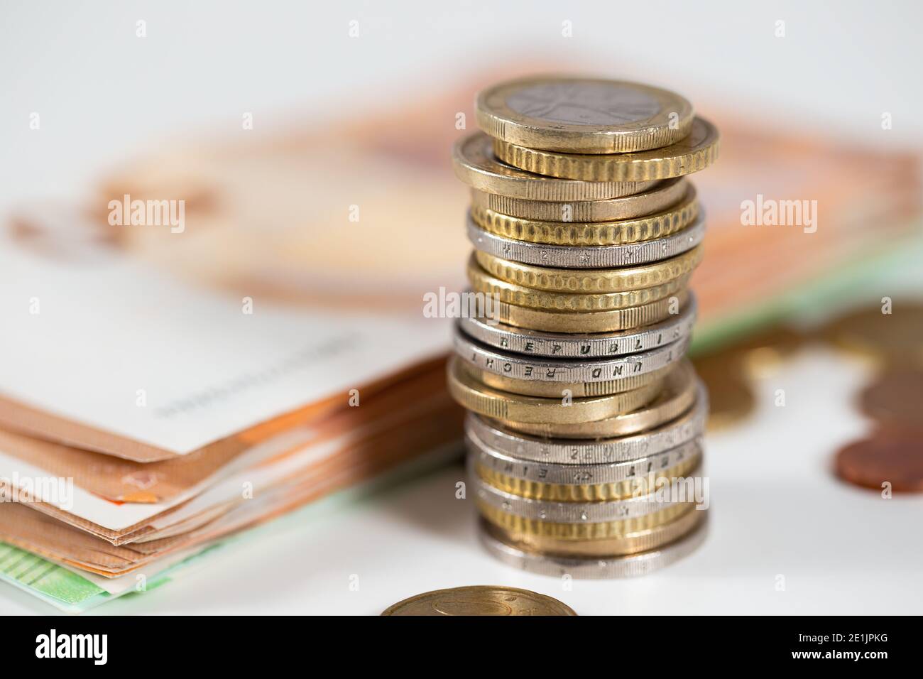 Coins lying on the table with banknotes blurred in the background Stock ...