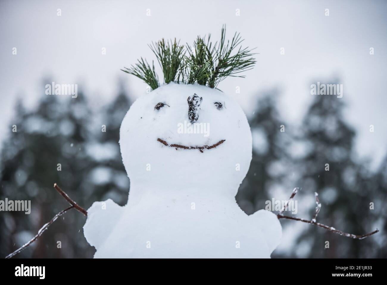 Funny snowman. Making a snowman, first snow Stock Photo - Alamy