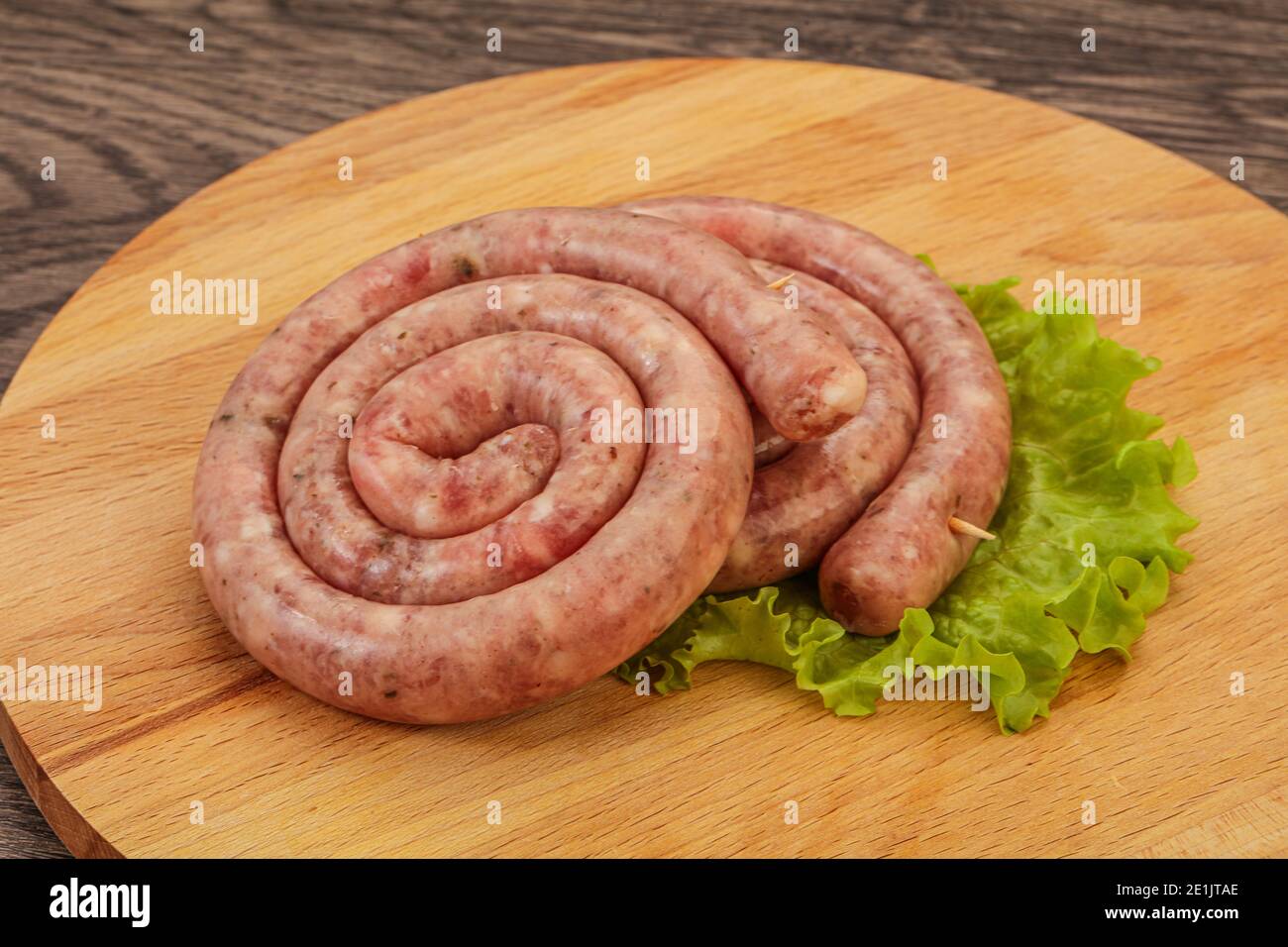 Raw pork sausage ring for grill Stock Photo - Alamy