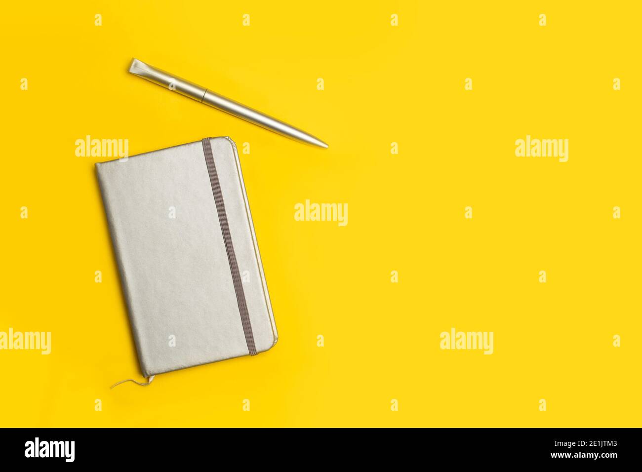 A gray diary and a pen on a yellow background with copy space Stock ...