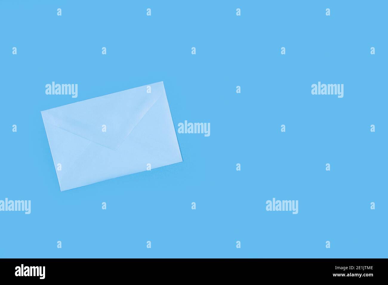 A light blue envelope on a blue background with copy space Stock Photo ...