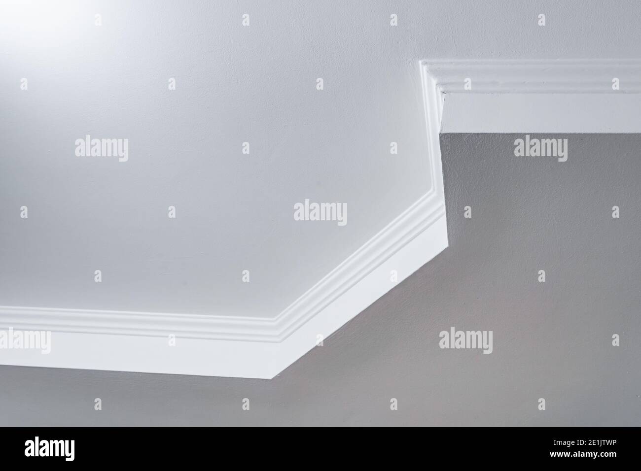 Detail of corner ceiling with intricate crown molding. Suspended ...