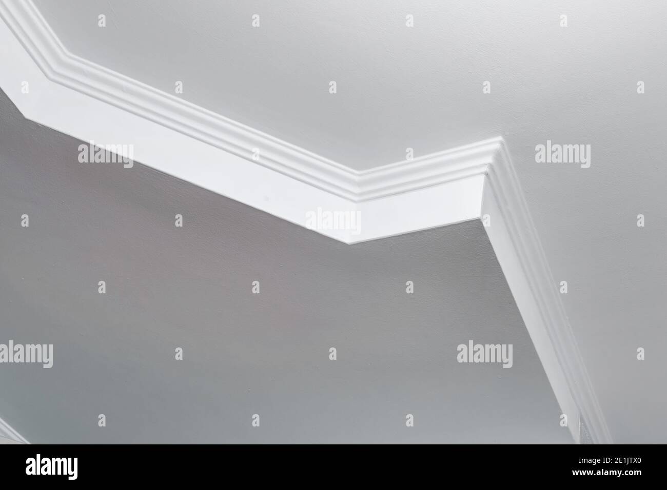 Detail of corner ceiling with intricate crown molding. Suspended ...