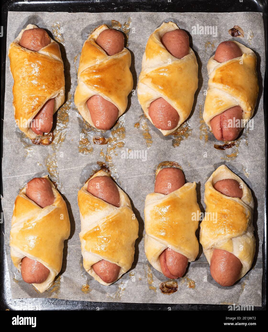 Top view. Hot baked hot dogs on a baking sheet. Cooking in the oven ...