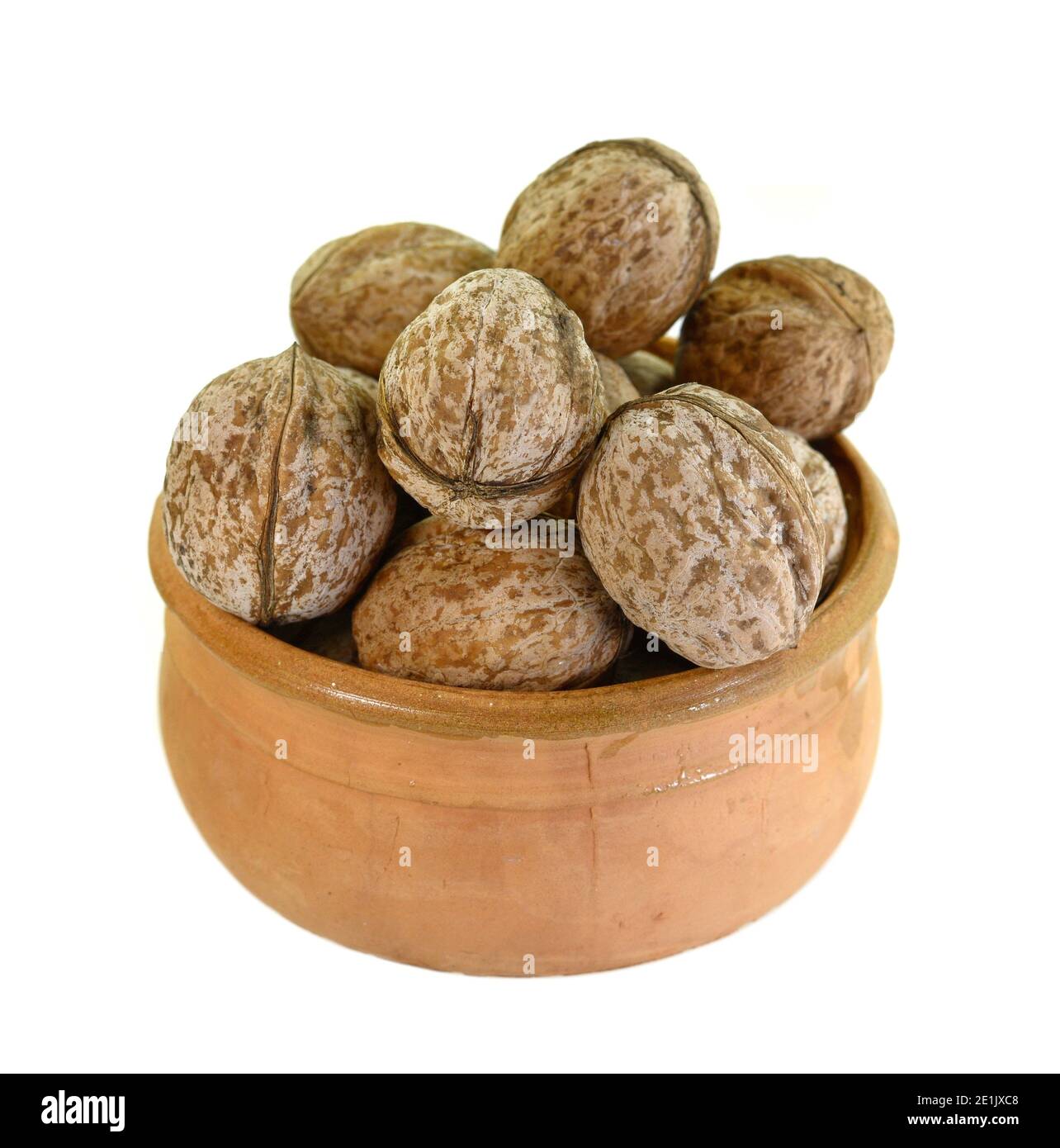 Walnut in a clay bowl isolated on white background Stock Photo - Alamy