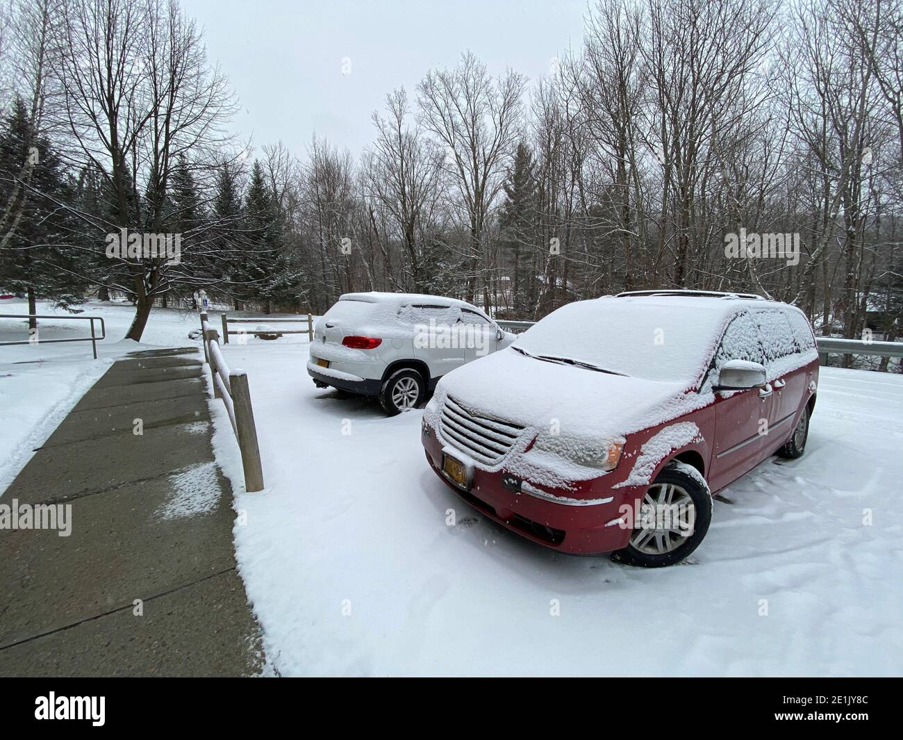 Fresh snow and snowflakes on the top of red car windows after early ...