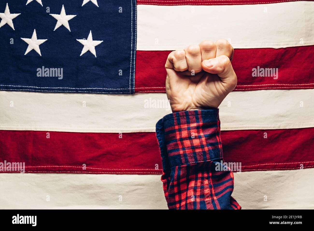 Hand clenched into fist against Us flag. Strength, power and ...