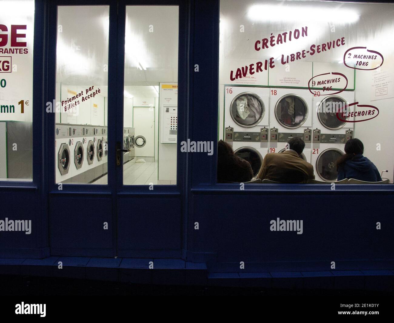 Customers waiting at a Coin Laundry Self-Service Laundromat Stock Photo ...