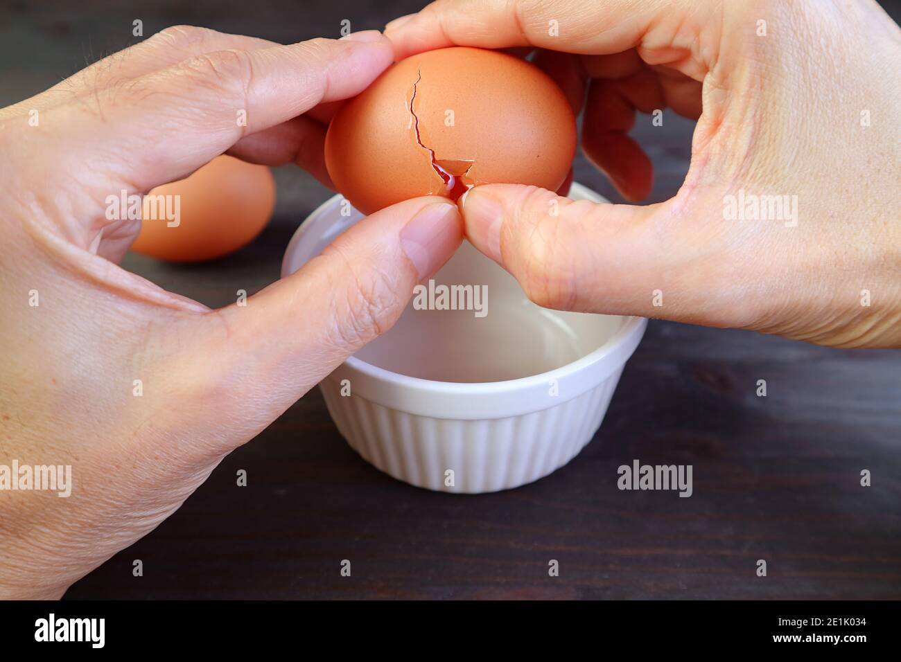 Hand breaking egg hi-res stock photography and images - Alamy