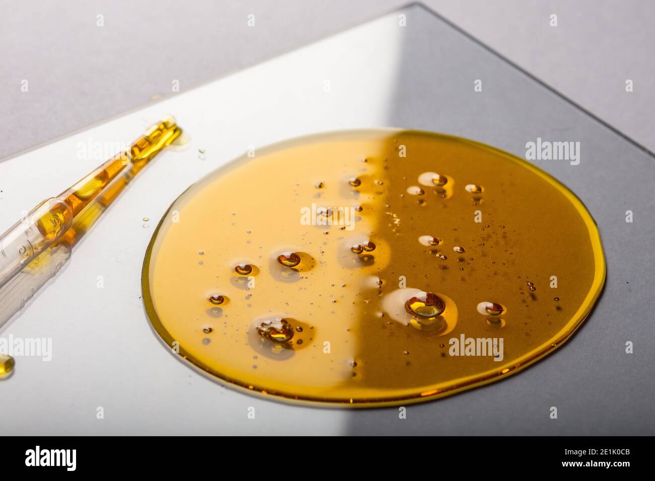Yellow viscous liquid lecithin with bubbles on glass Stock Photo - Alamy