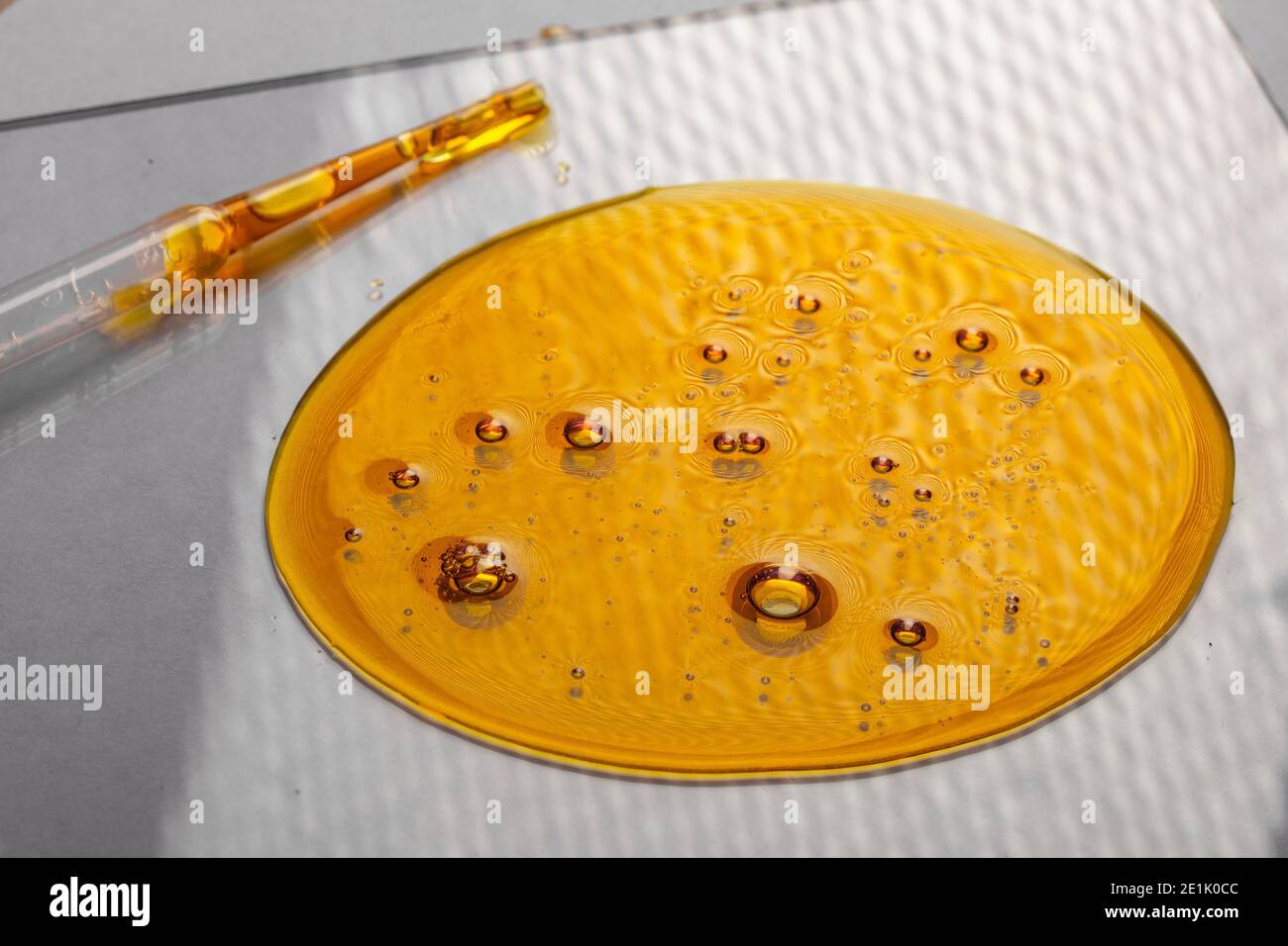 Yellow viscous liquid lecithin with bubbles on glass Stock Photo - Alamy