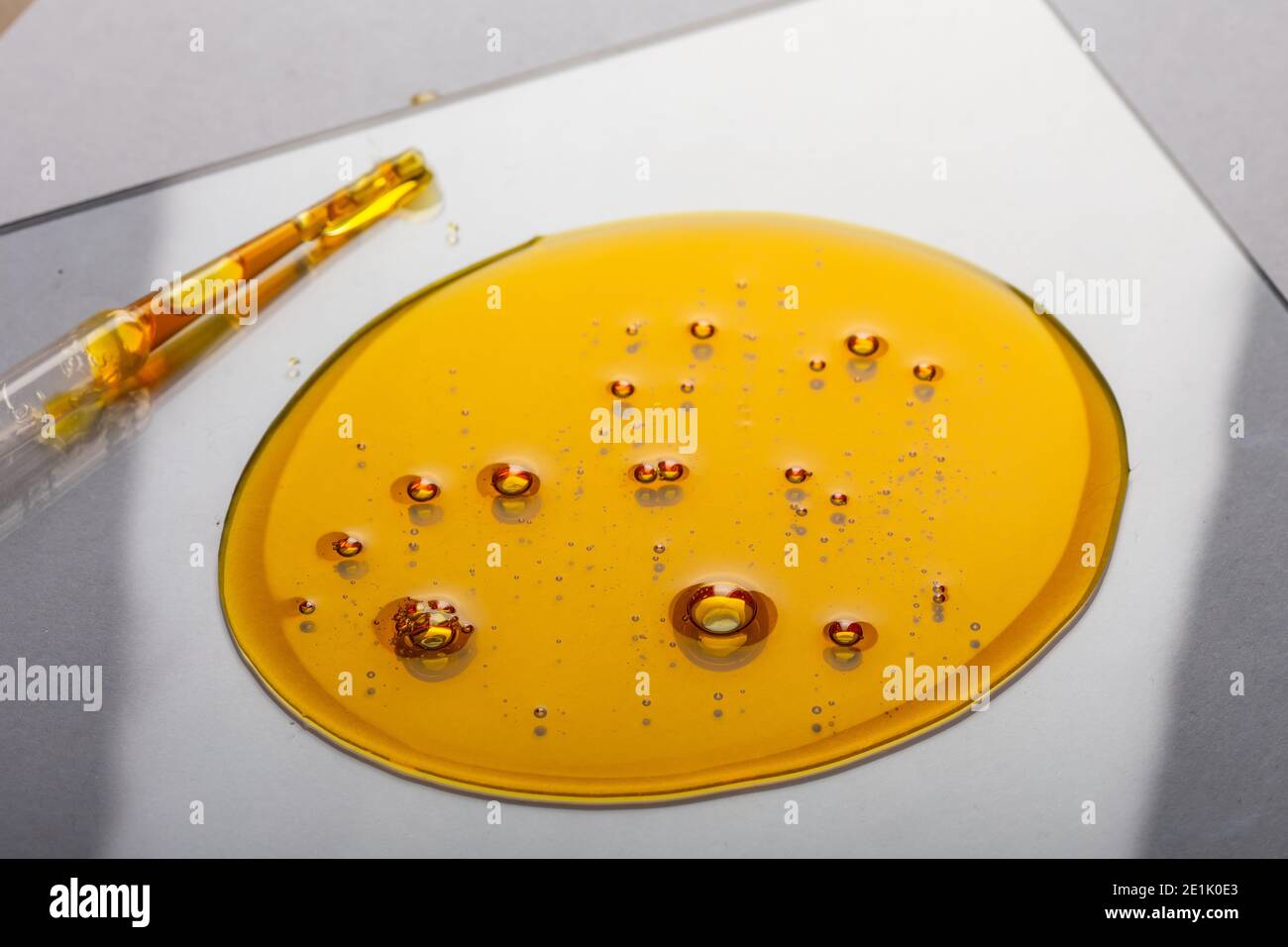 Yellow viscous liquid lecithin with bubbles on glass Stock Photo - Alamy