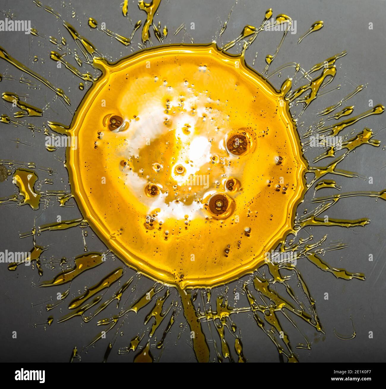 Yellow viscous liquid sunflower lecithin with bubbles on glass in the ...