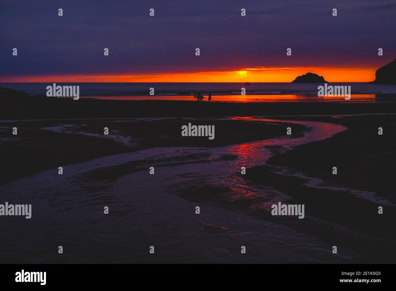 A dramatic sunset at the end of the day on the main beach at Polzeath ...