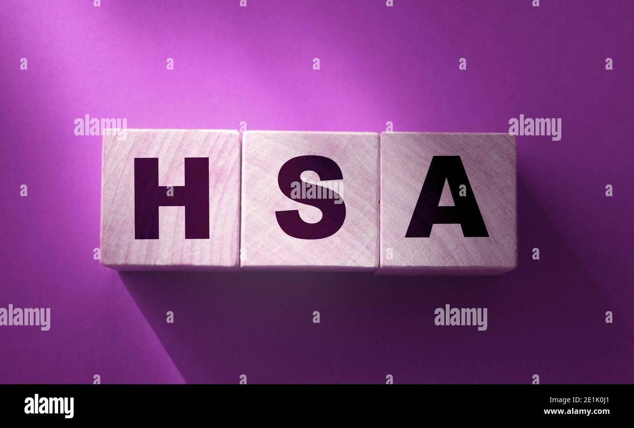 HSA abbreviation is written on wooden cubes on red backgrond. Concept ...