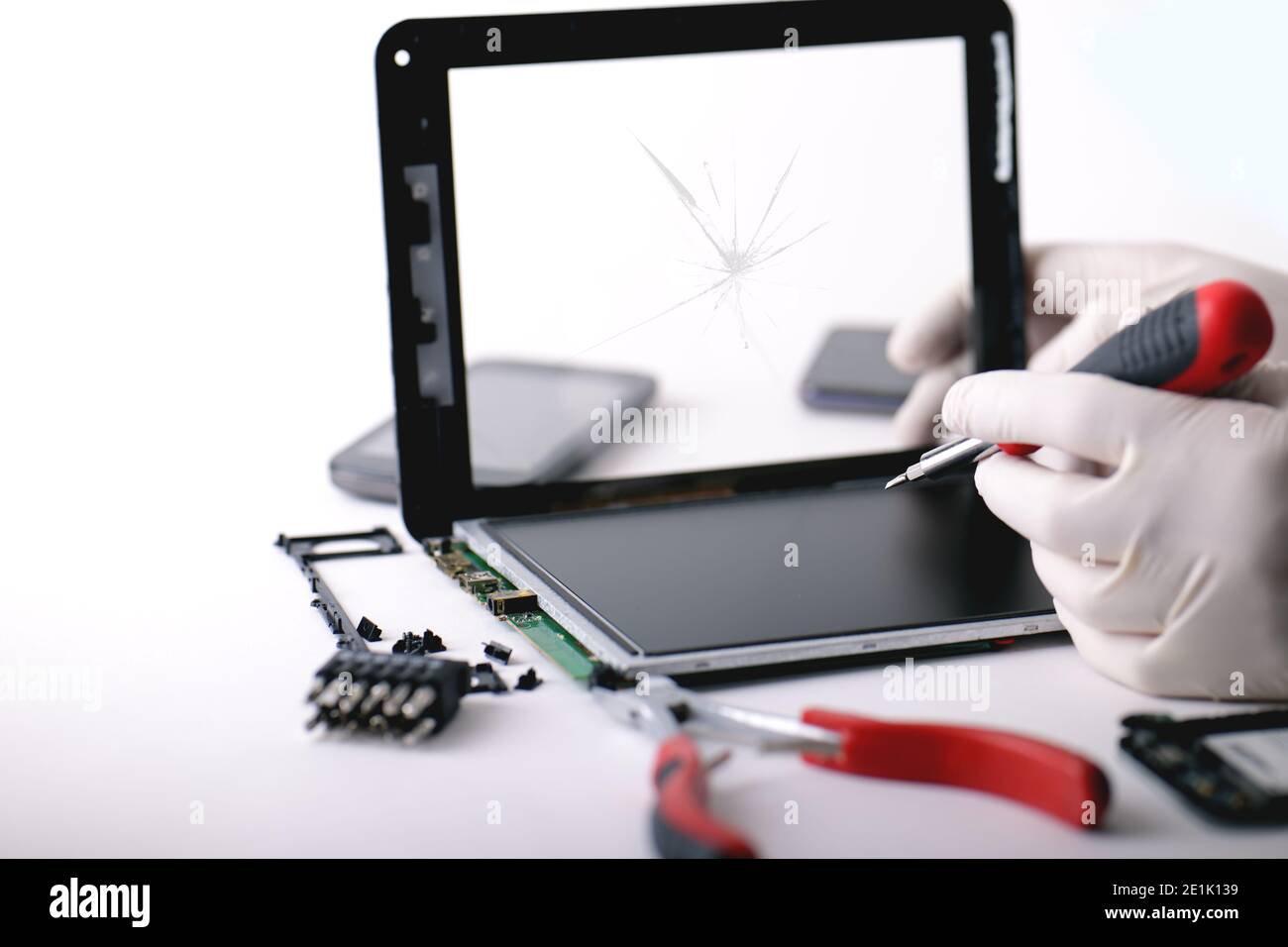 A technician repairs a broken tablet Stock Photo - Alamy