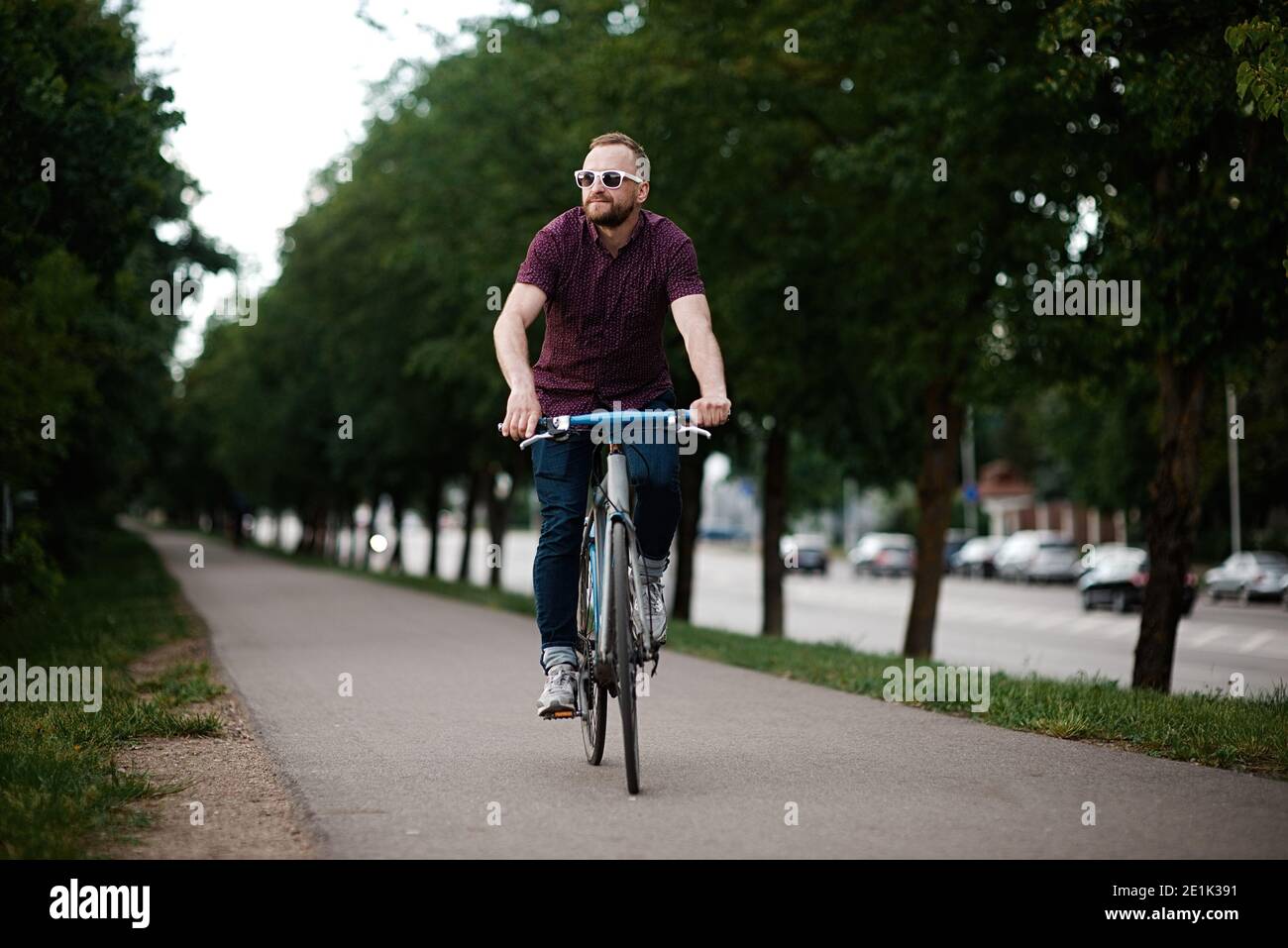 A handsome male with bicycle and backpack Stock Photo - Alamy