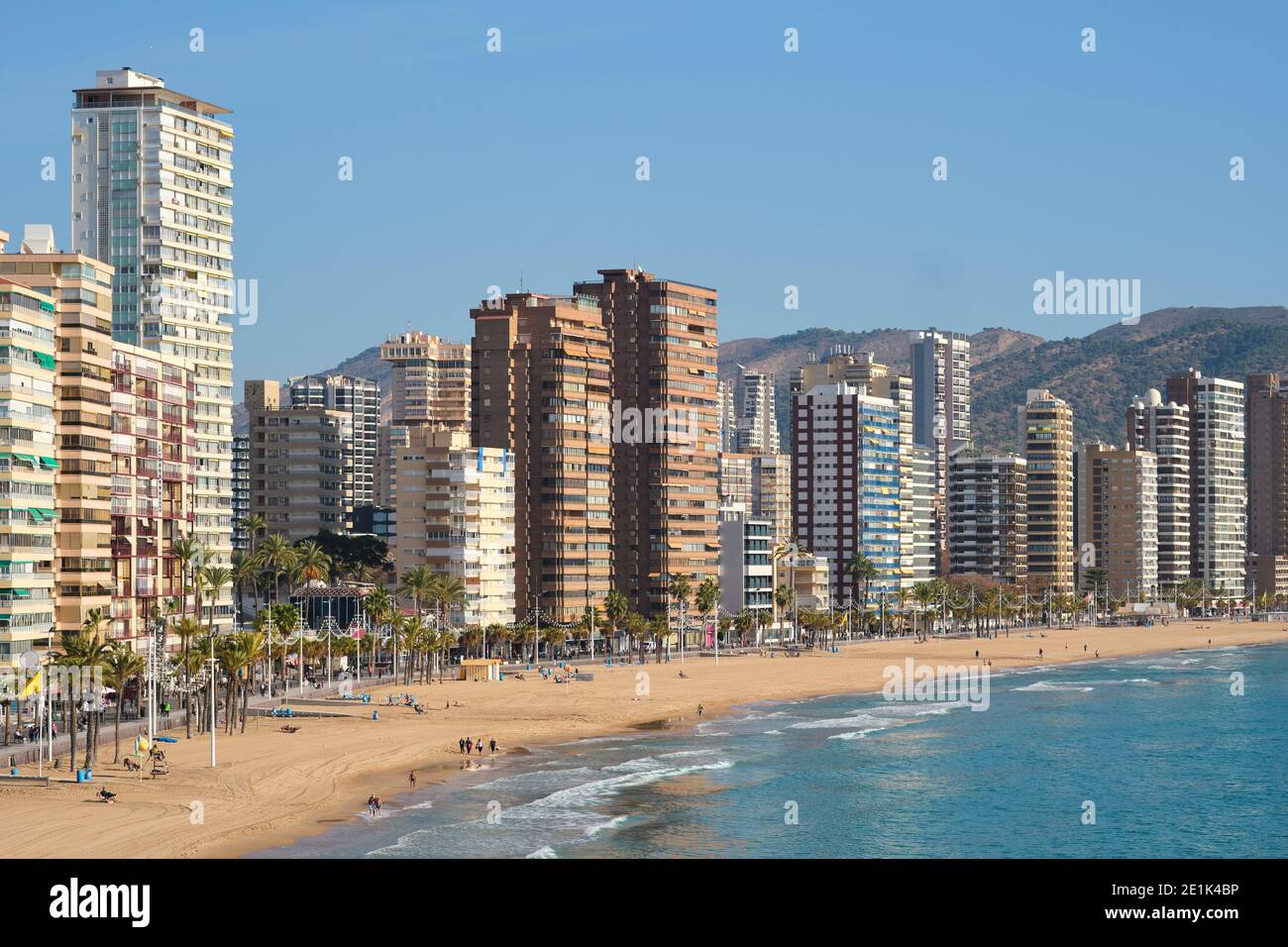 Coastline of Benidorm, city skyline over blue sky, sandy beach view ...