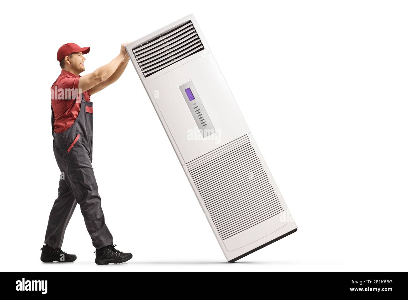 Worker installing a self standing portable air conditioning unit ...