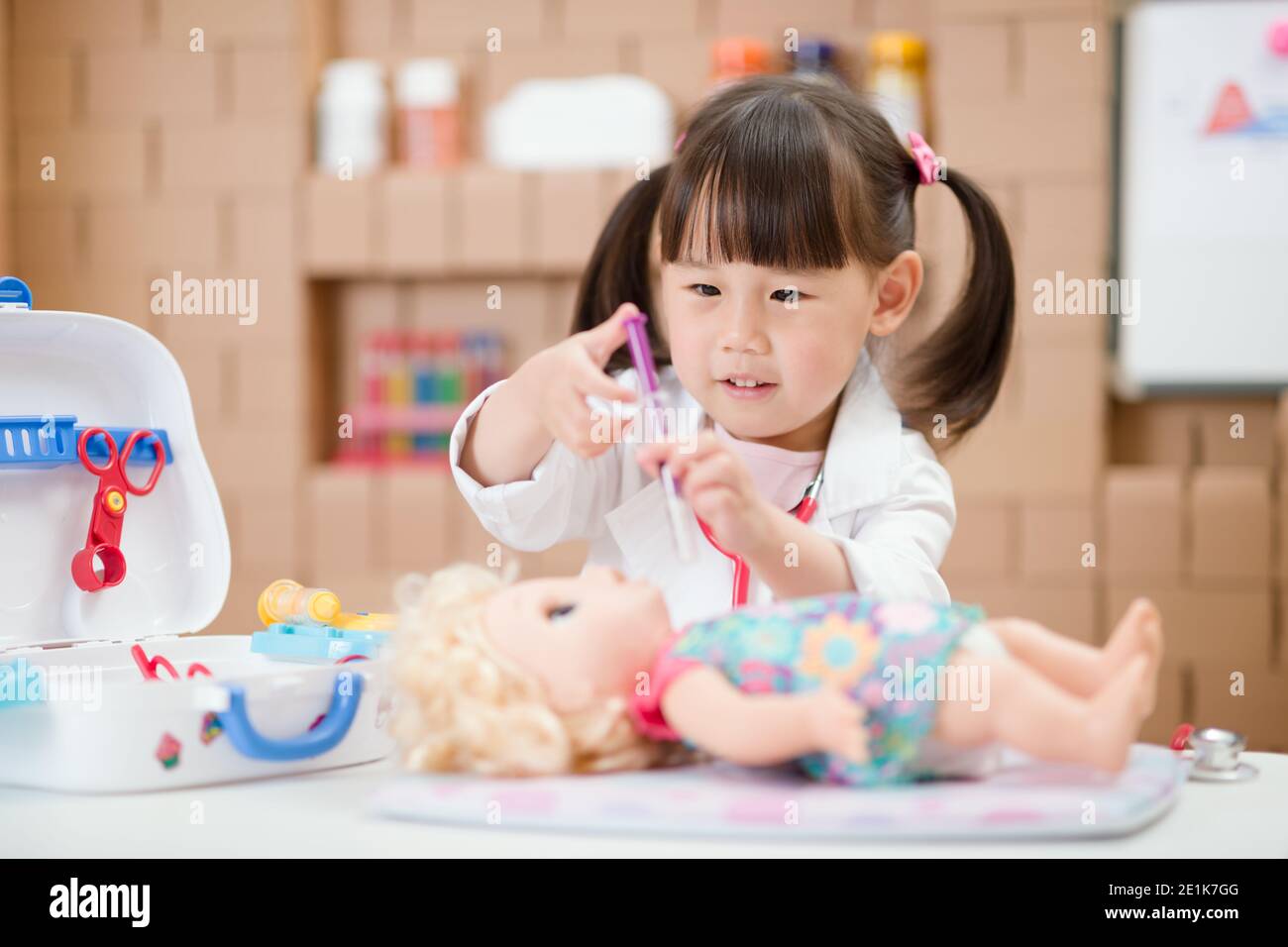 young girl pretend play doctor role at home Stock Photo - Alamy