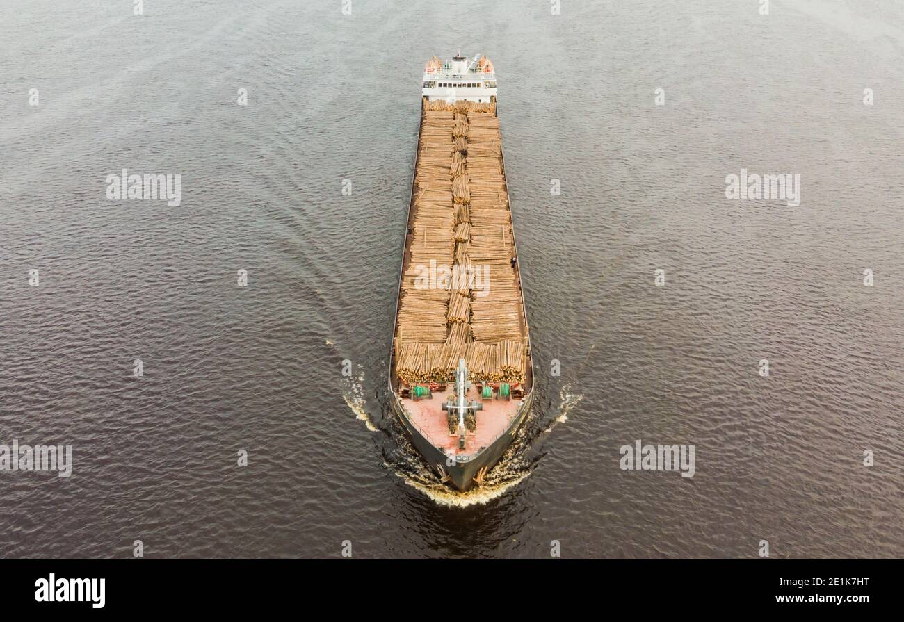 Timber ship goes by sea. Transportation of logs Stock Photo - Alamy