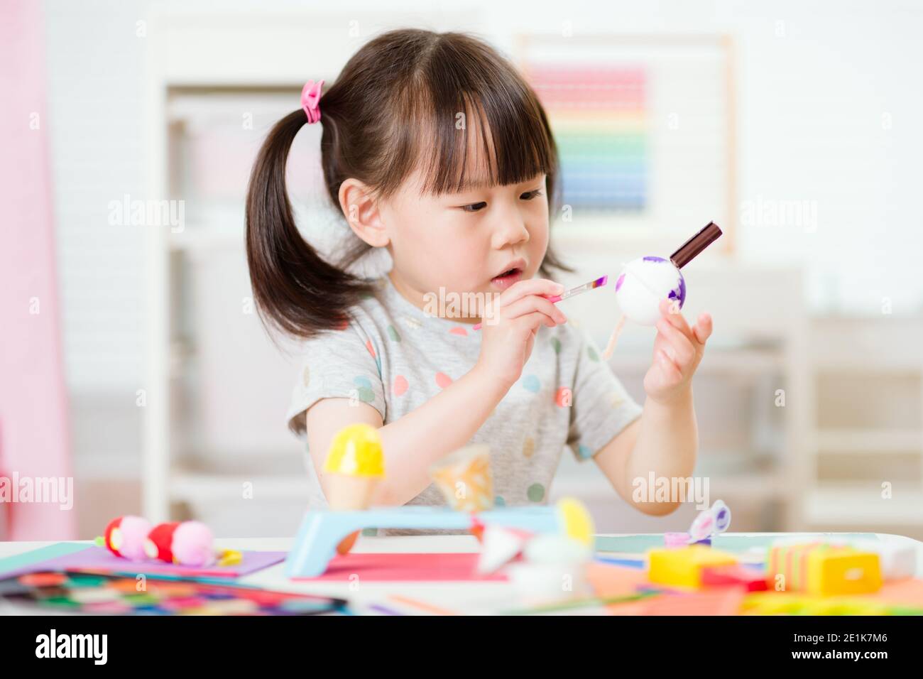 young girl decorating hand made craft for homeschooling Stock Photo - Alamy