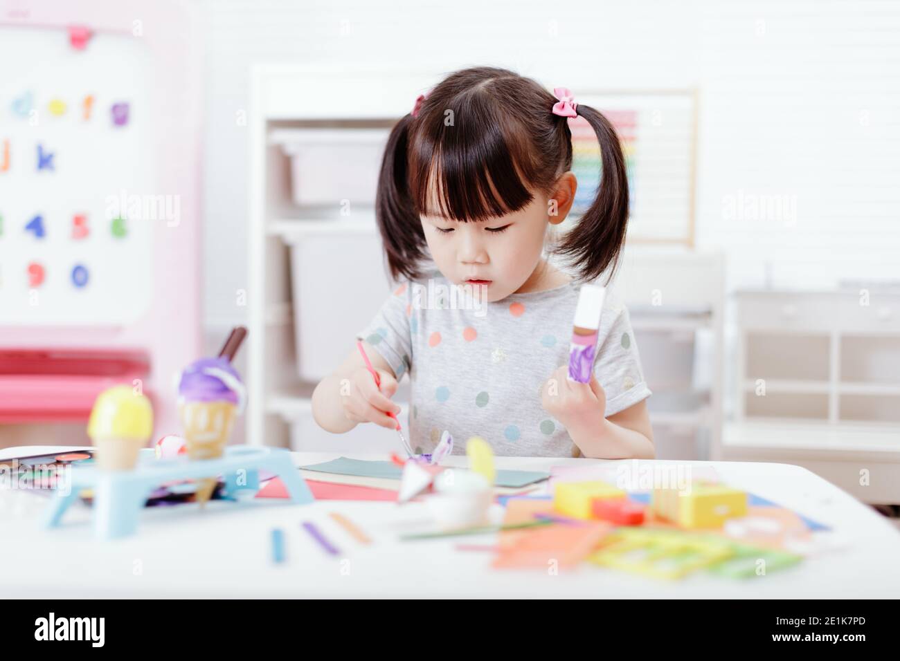 young girl decorating hand made craft for homeschooling Stock Photo - Alamy