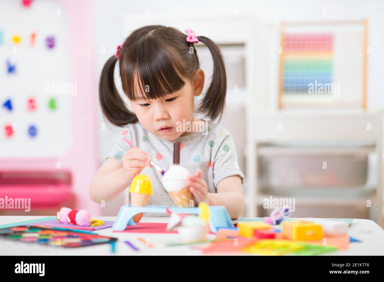 young girl decorating hand made craft for homeschooling Stock Photo - Alamy