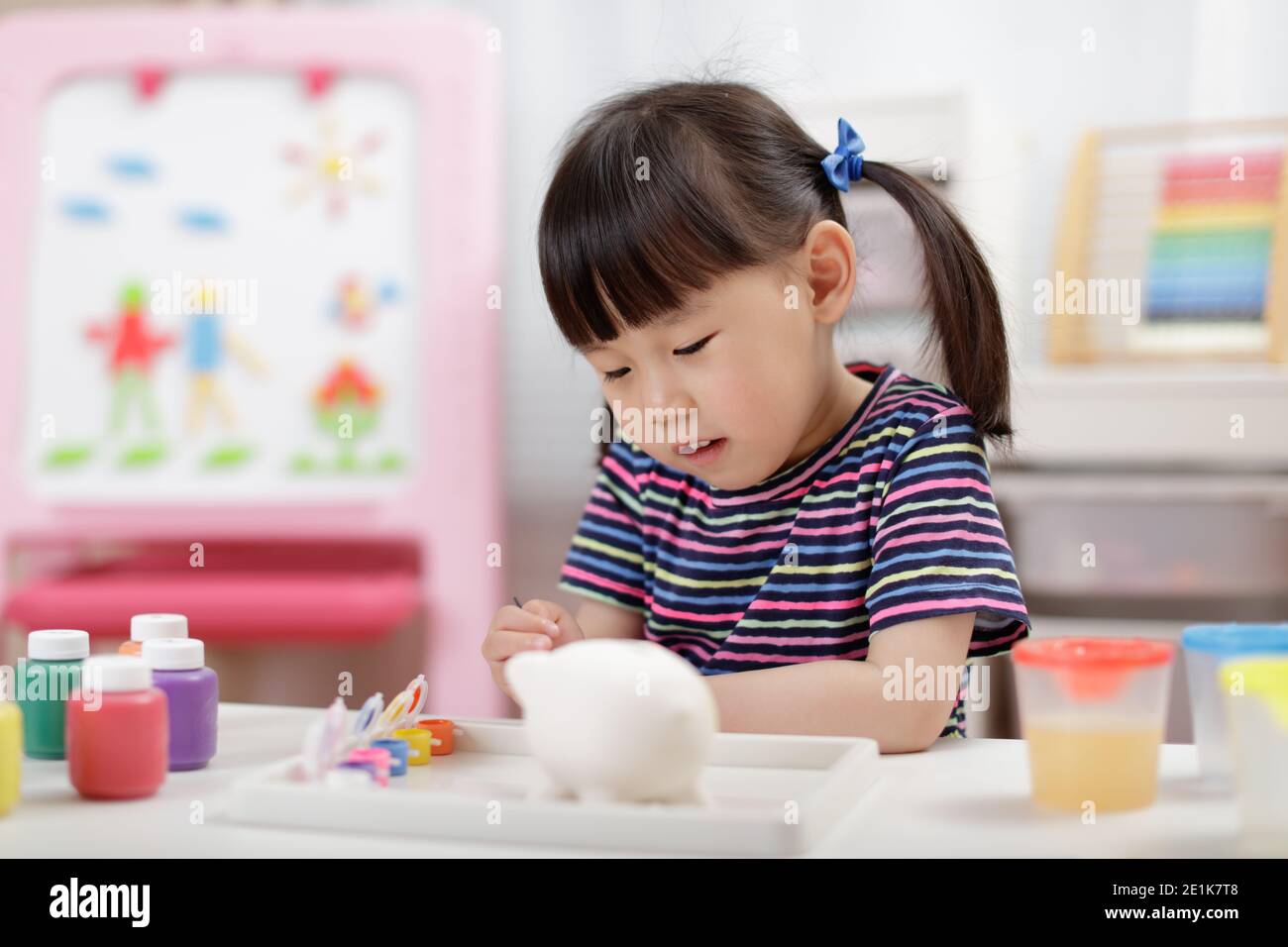 young girl decorating hand made craft for homeschooling Stock Photo - Alamy