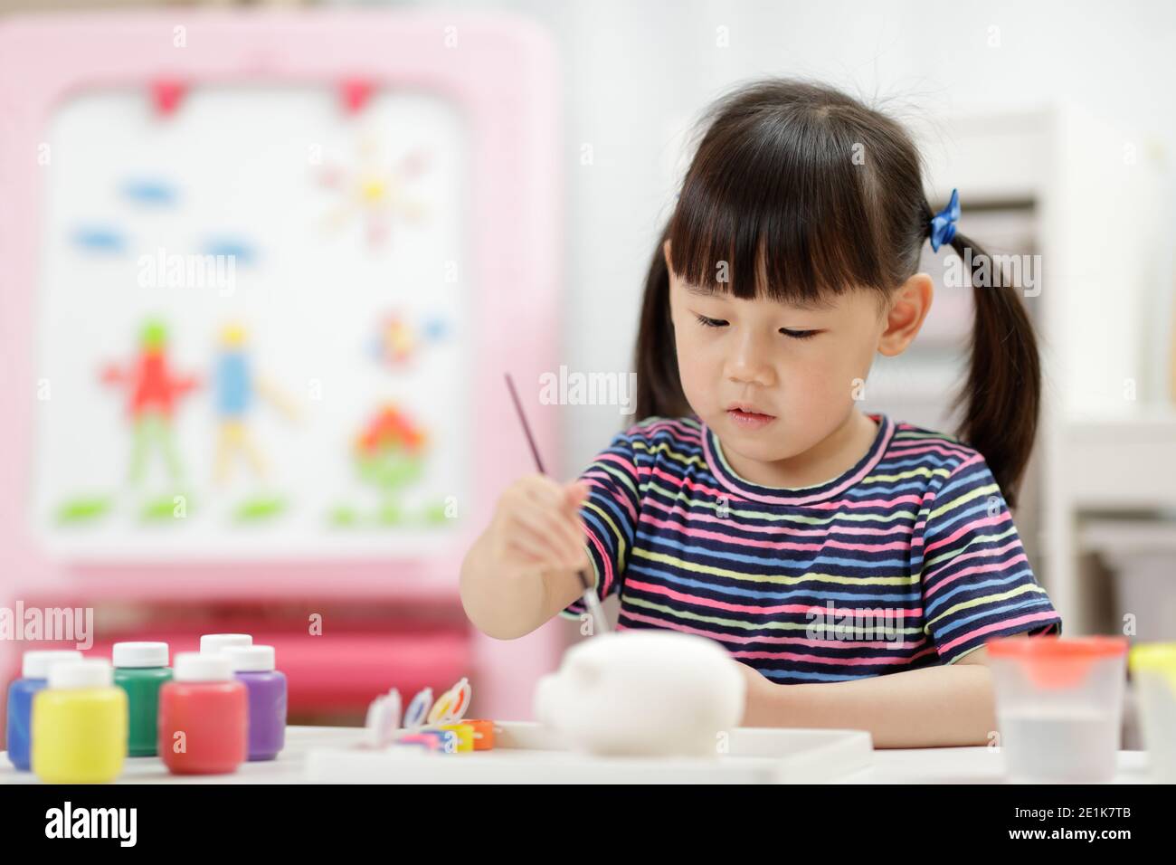 young girl decorating hand made craft for homeschooling Stock Photo - Alamy