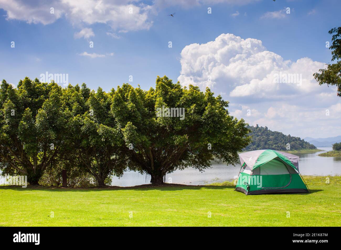 Camping tent on green grass field under clear sky Stock Photo - Alamy