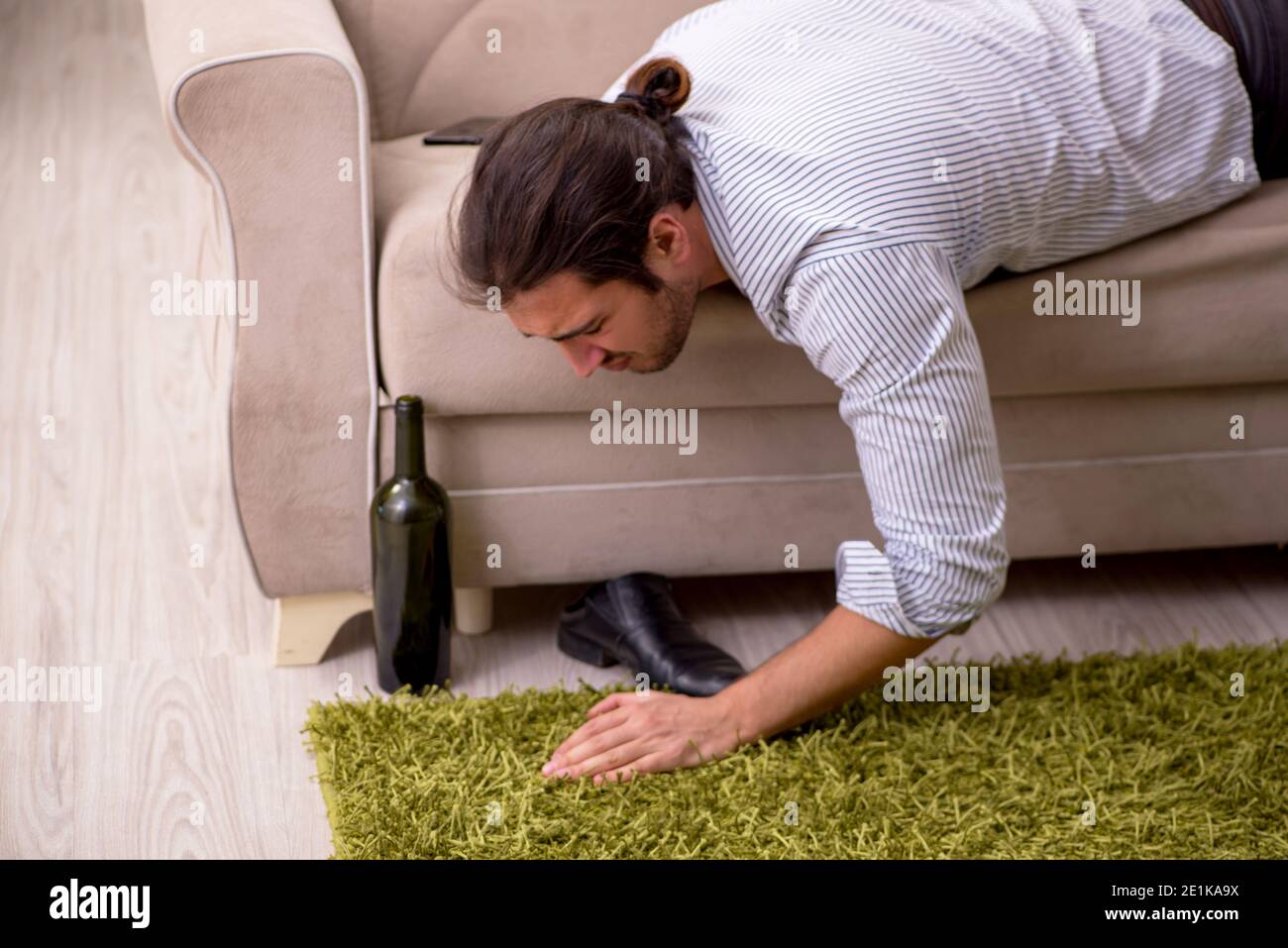 Young drunken man suffering at home Stock Photo - Alamy