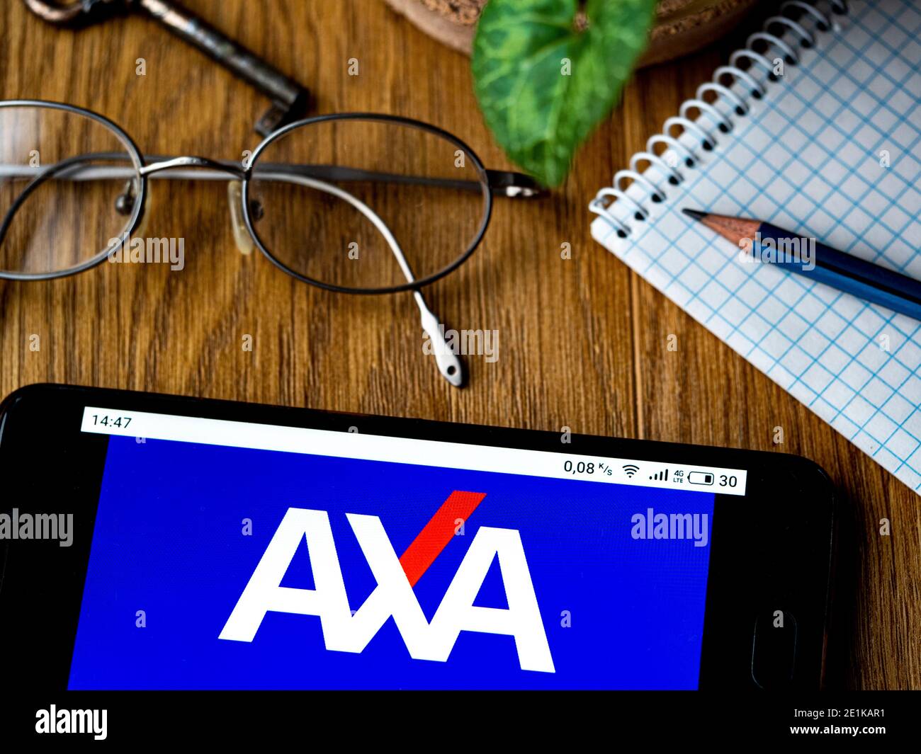 In this photo illustration an AXA Group, logo seen displayed on a ...