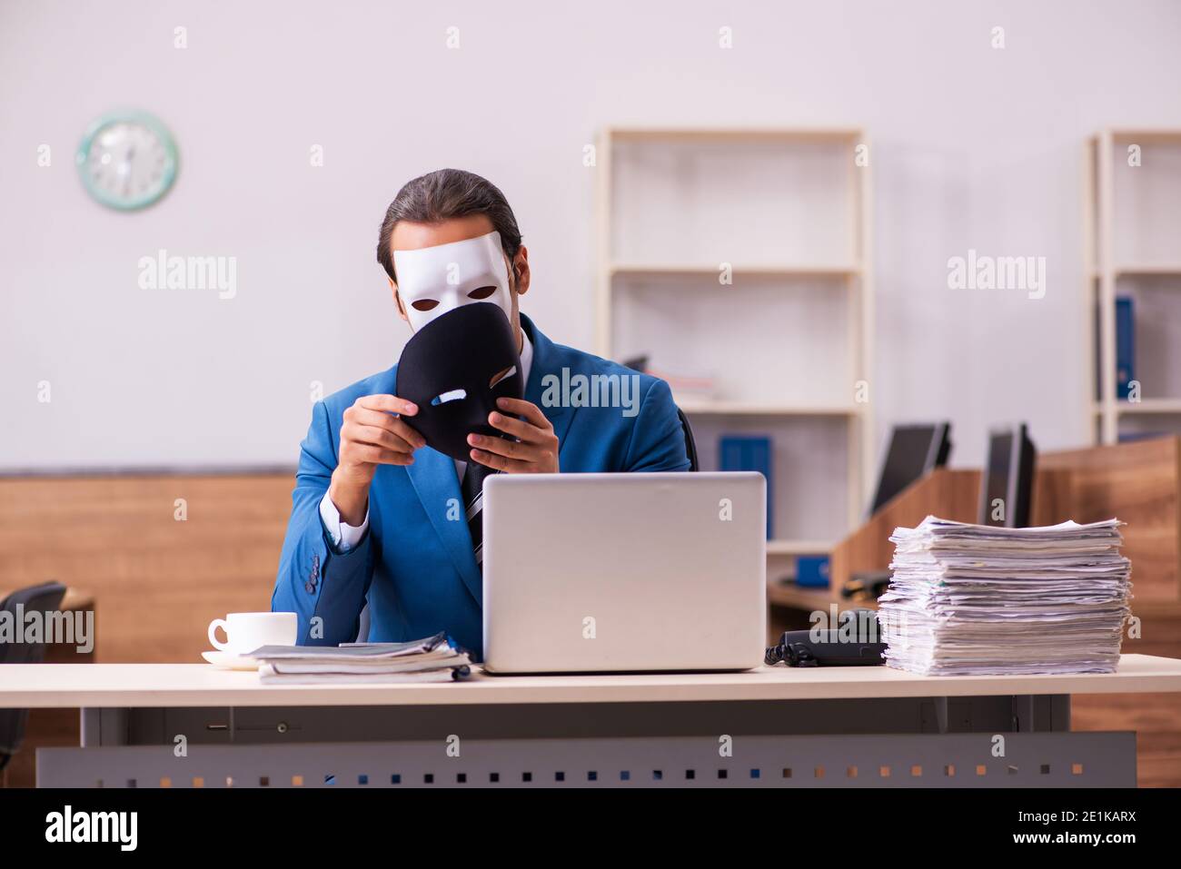 Young employee wearing masks in the office Stock Photo - Alamy
