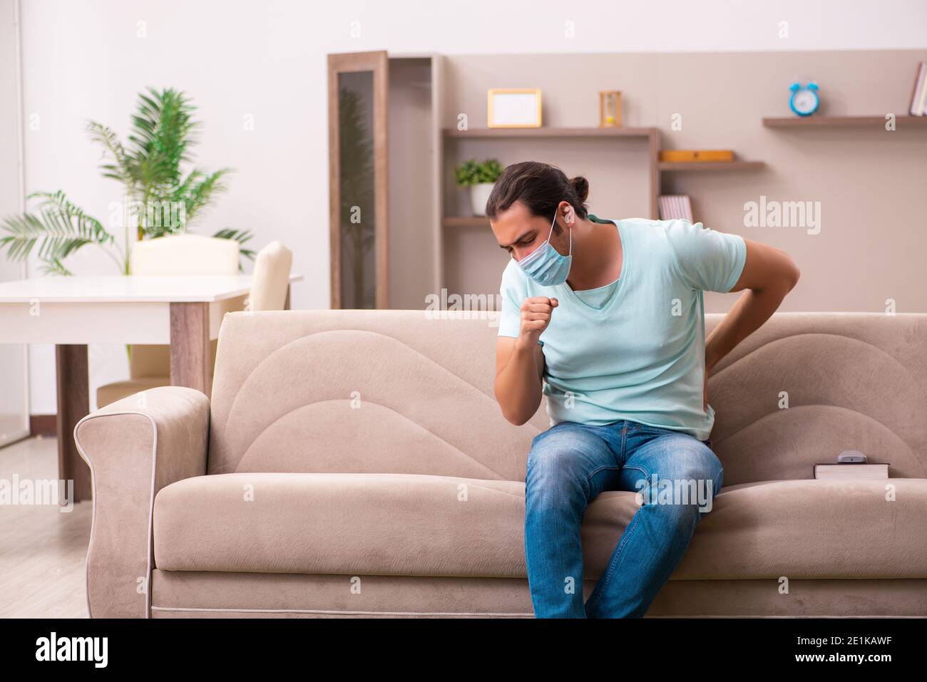 Young man student coughing at home during pandemic Stock Photo - Alamy