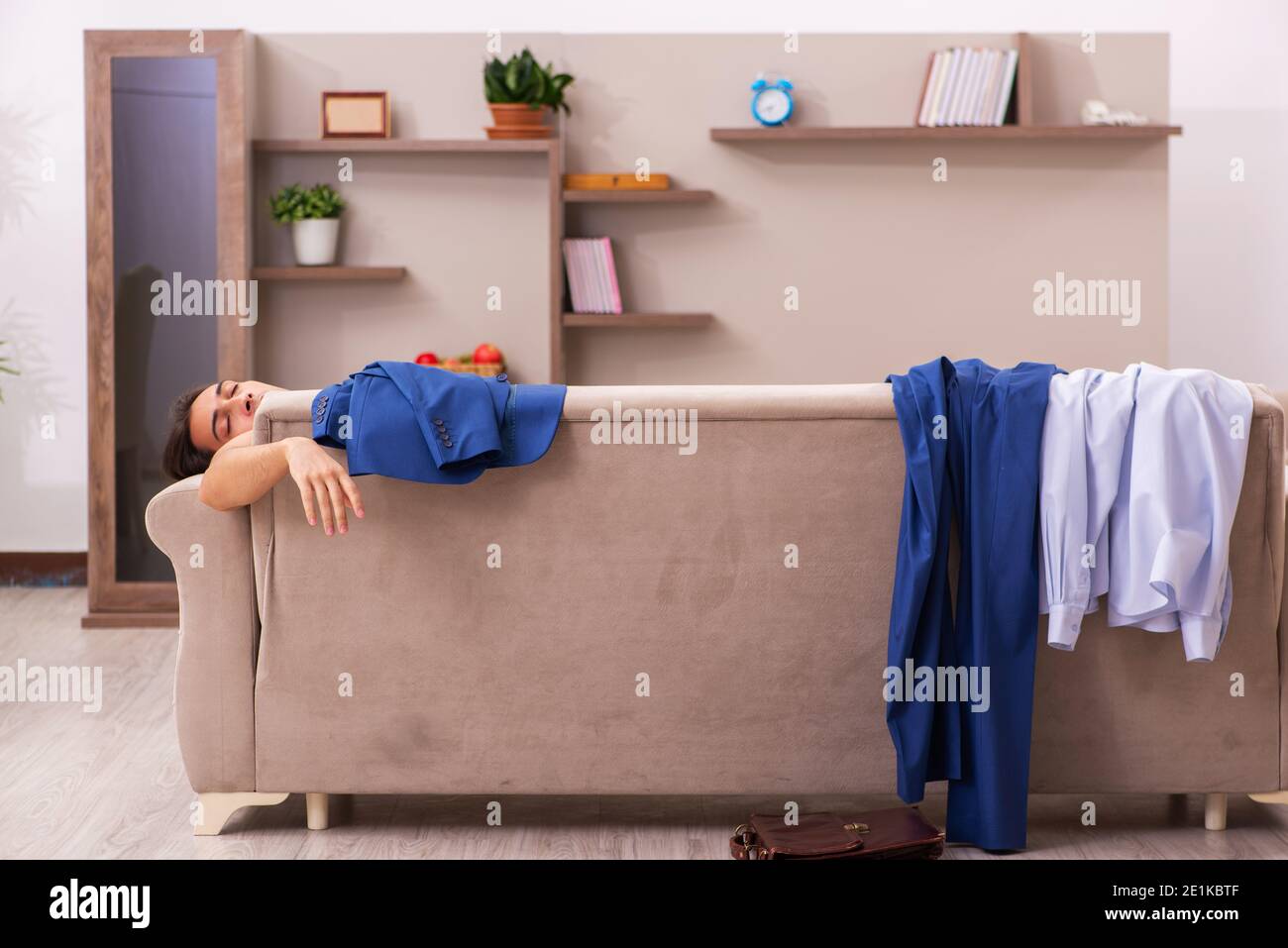 Young employee getting up late at home Stock Photo - Alamy