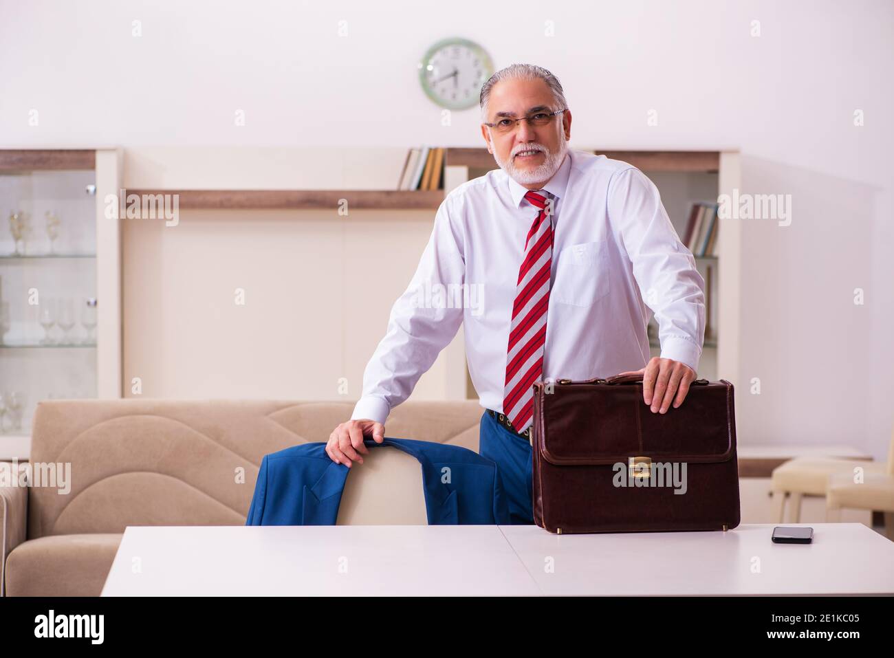 Senior male boss employee coming home from work Stock Photo - Alamy