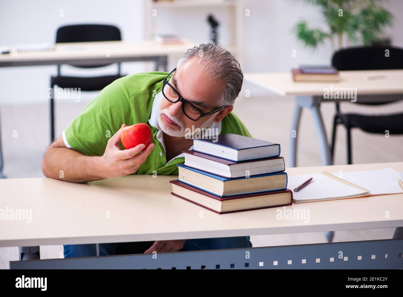 Male teacher eating apple hi-res stock photography and images - Alamy