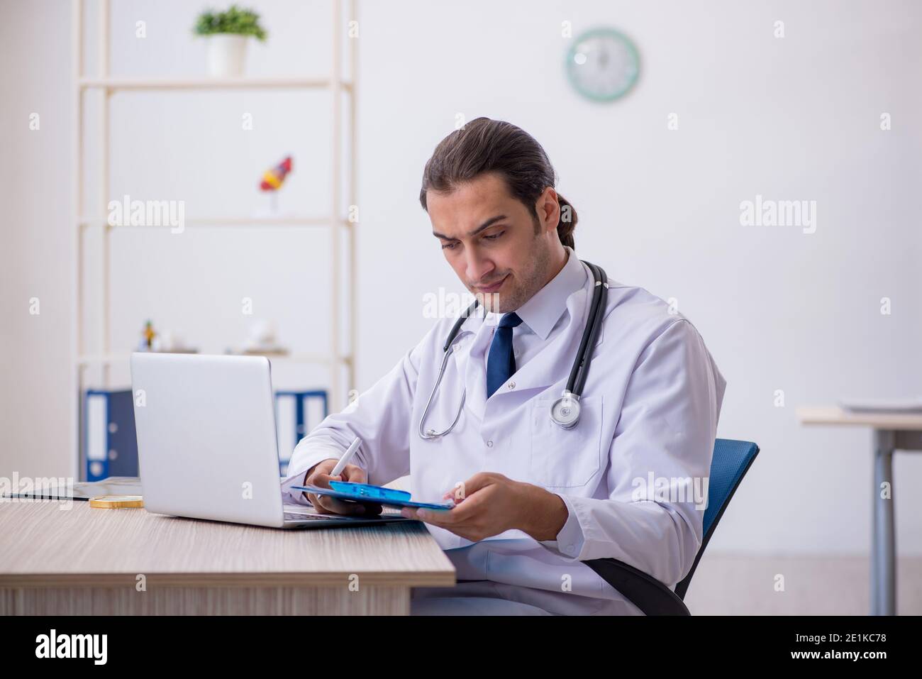 Young doctor taking notes at the hospital Stock Photo - Alamy