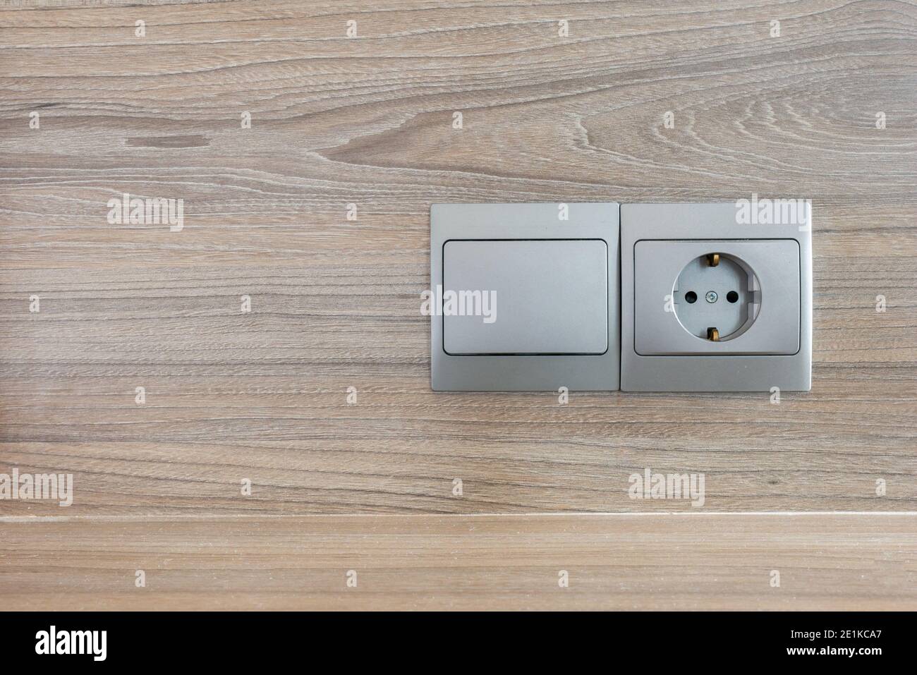 Electric plug grey color with wooden background Stock Photo - Alamy